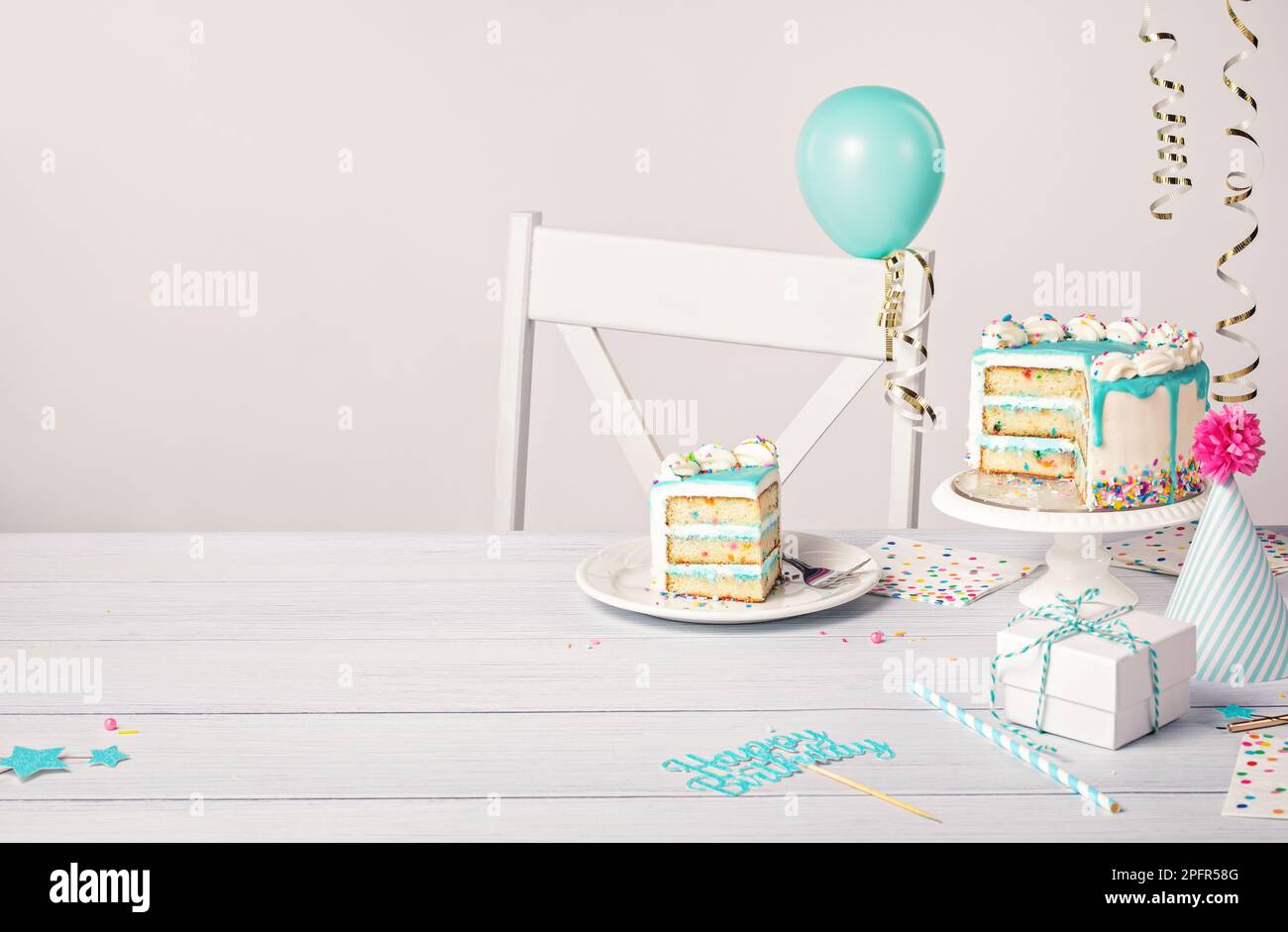 Happy Birthday party table setting with a sliced vanilla buttercream ...