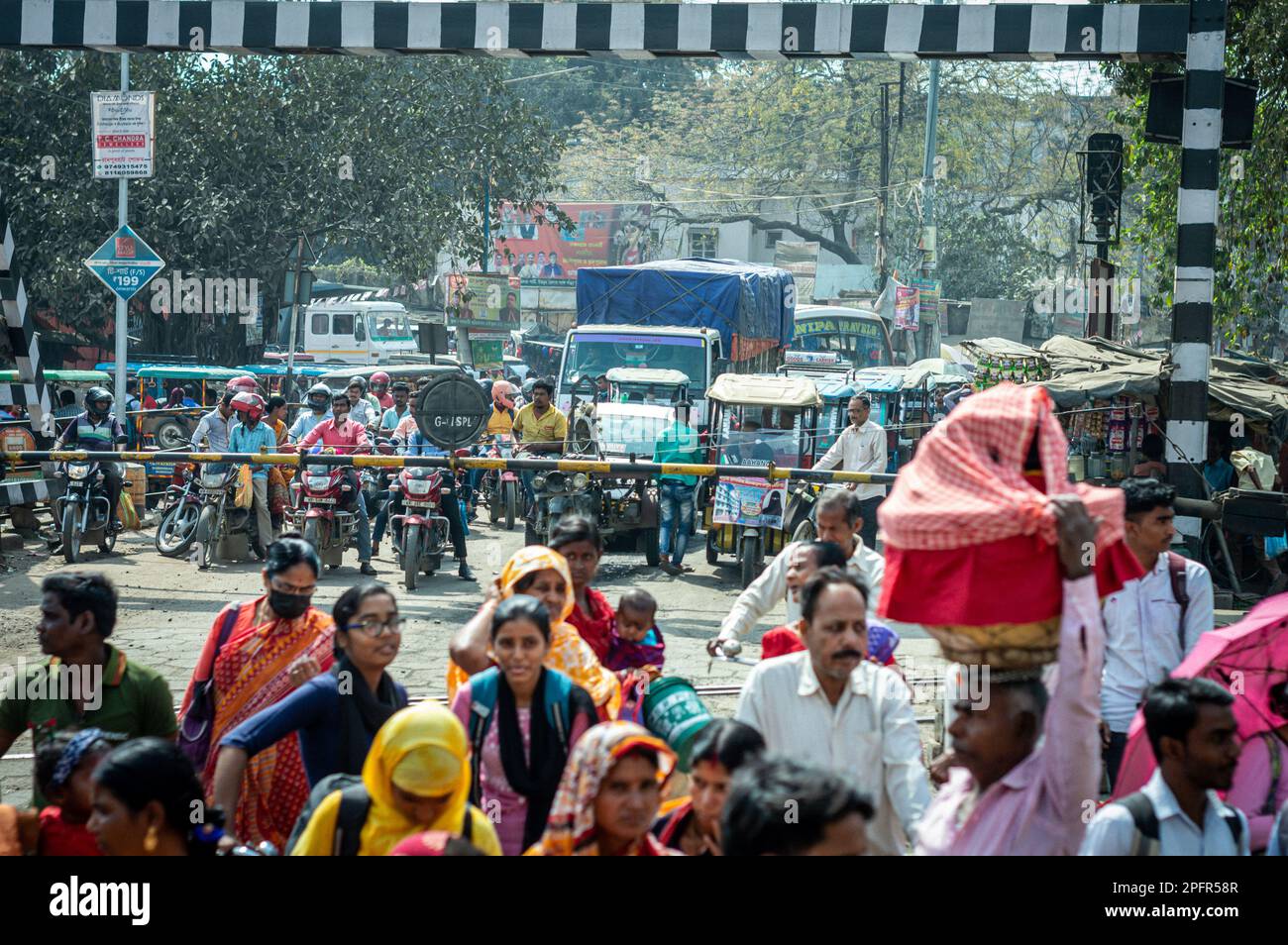 Crowd of People standing near an Indian Railway level crossing. Focus ...