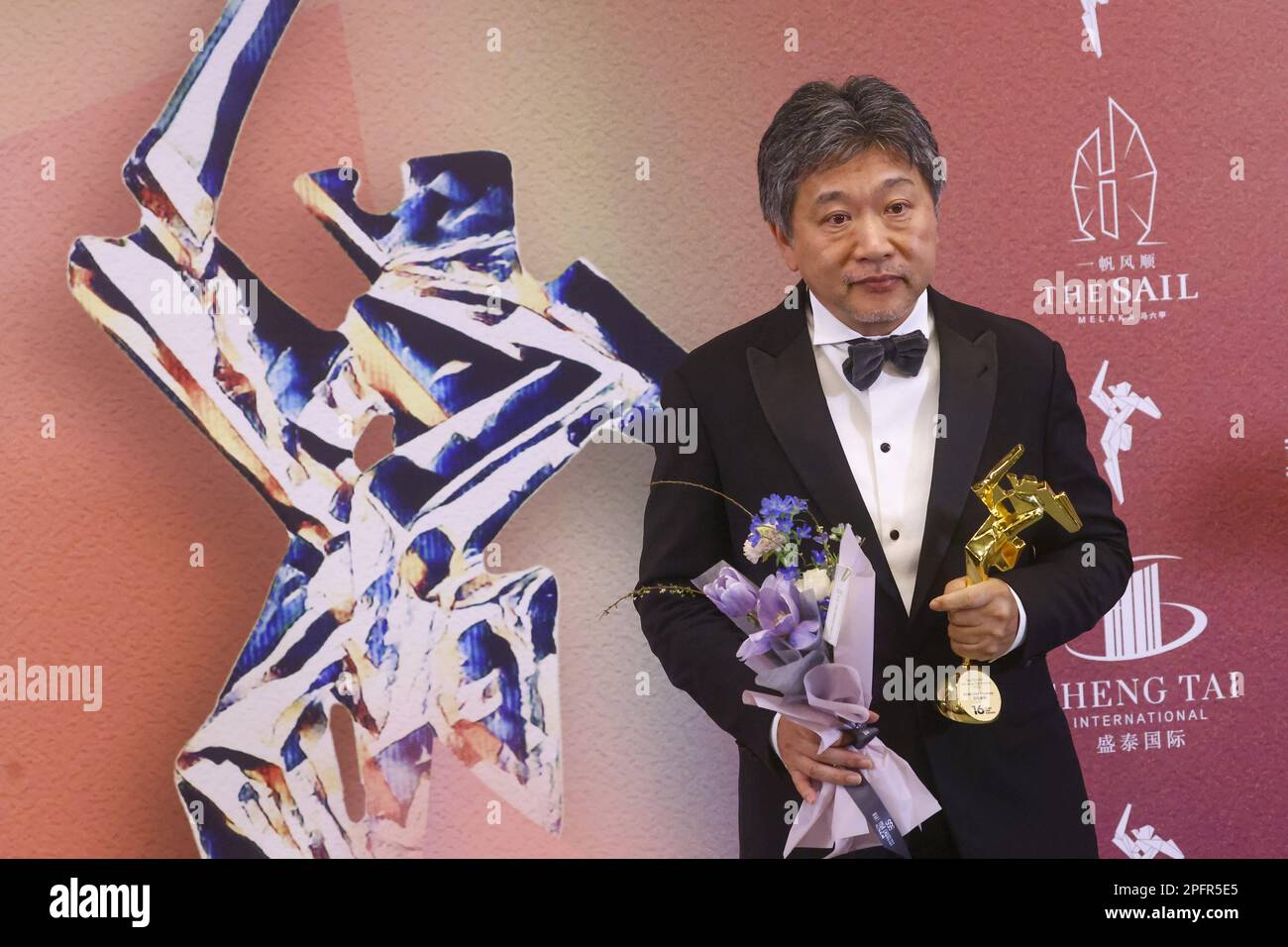 Japanese Director Hirokazu Koreeda poses with his award after winning ...