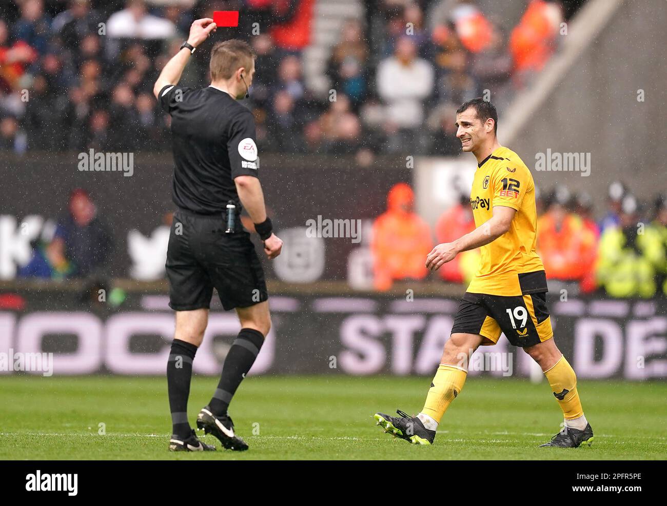 Wolverhampton Wanderers' Jonny (right) is shown a red card by referee ...