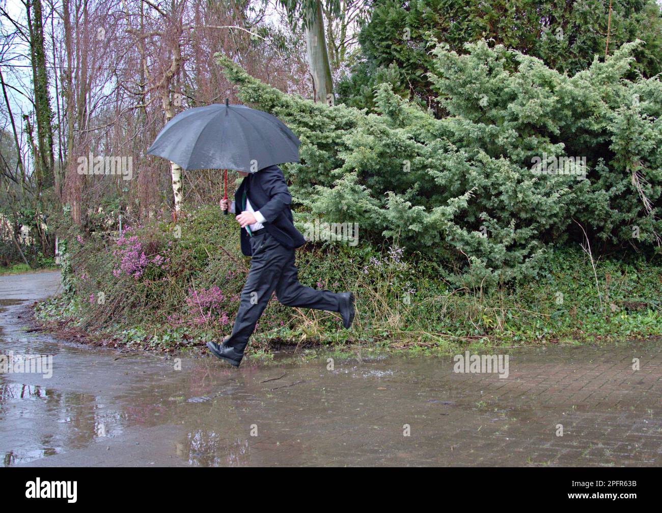 Man running in the rain Stock Photo - Alamy