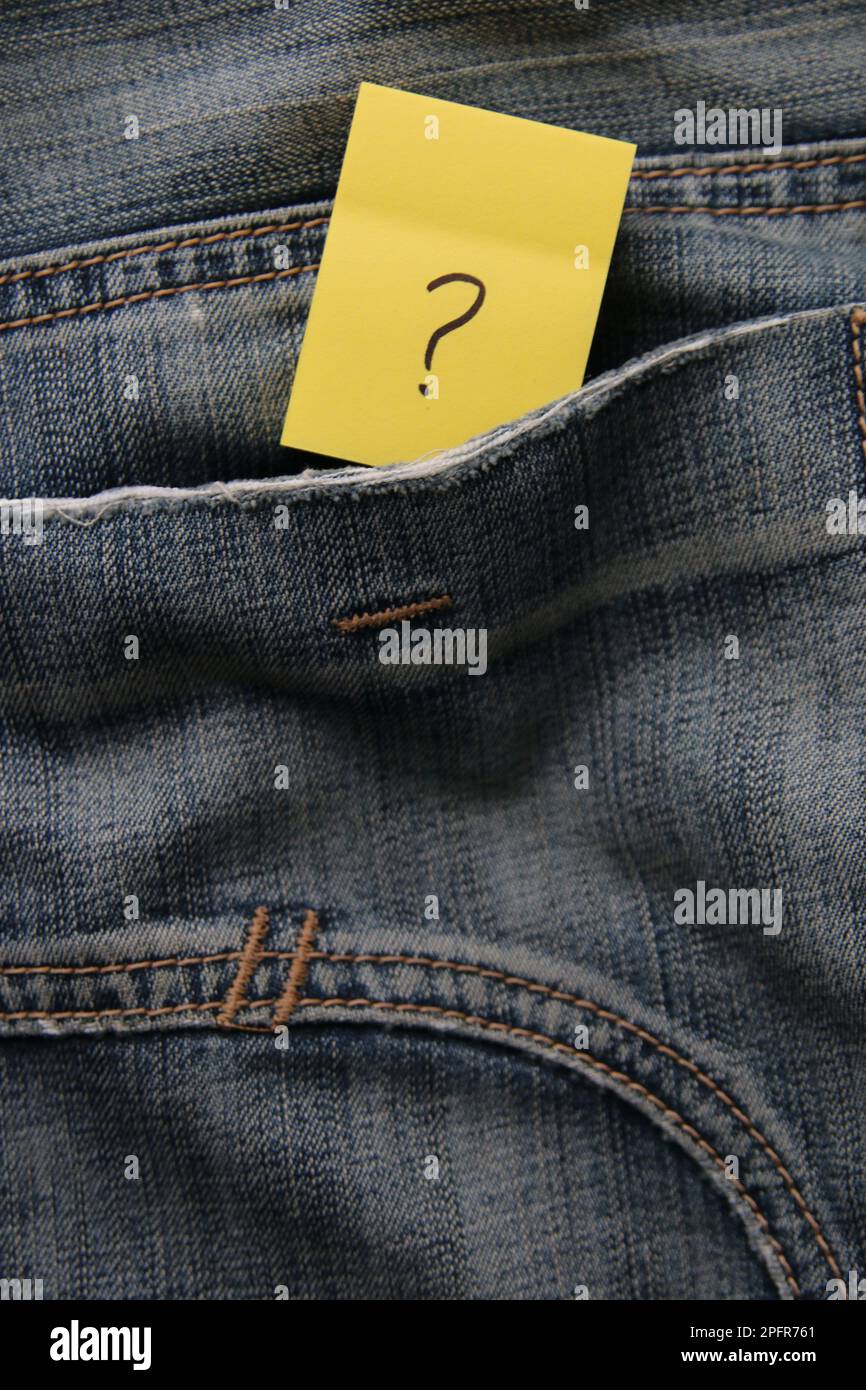 A question mark on a paper tag in a jeans pocket. Question mark on ...