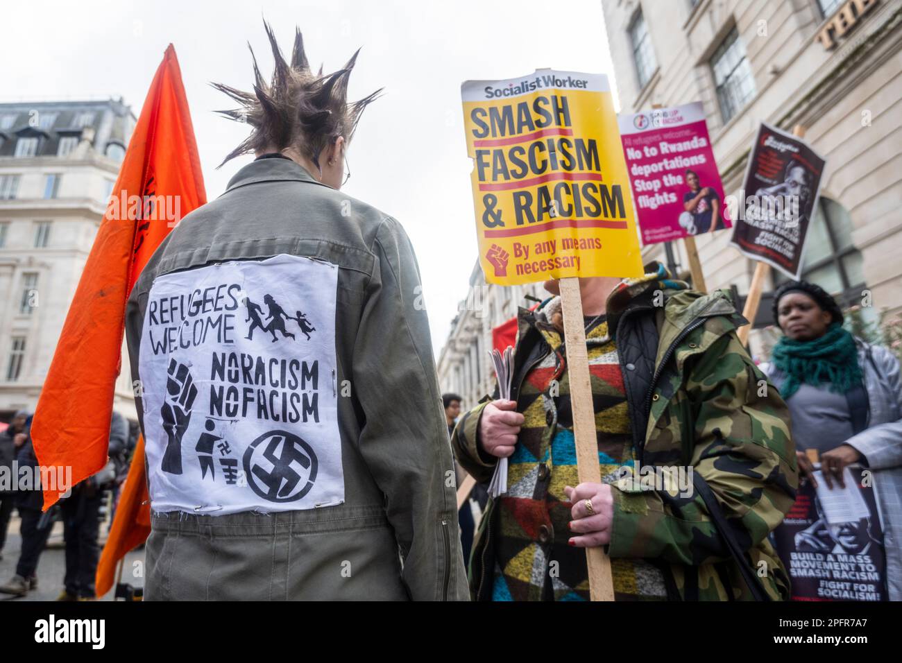 London, UK. 18 March 2023. A woman with a punk hairstyle outside the ...