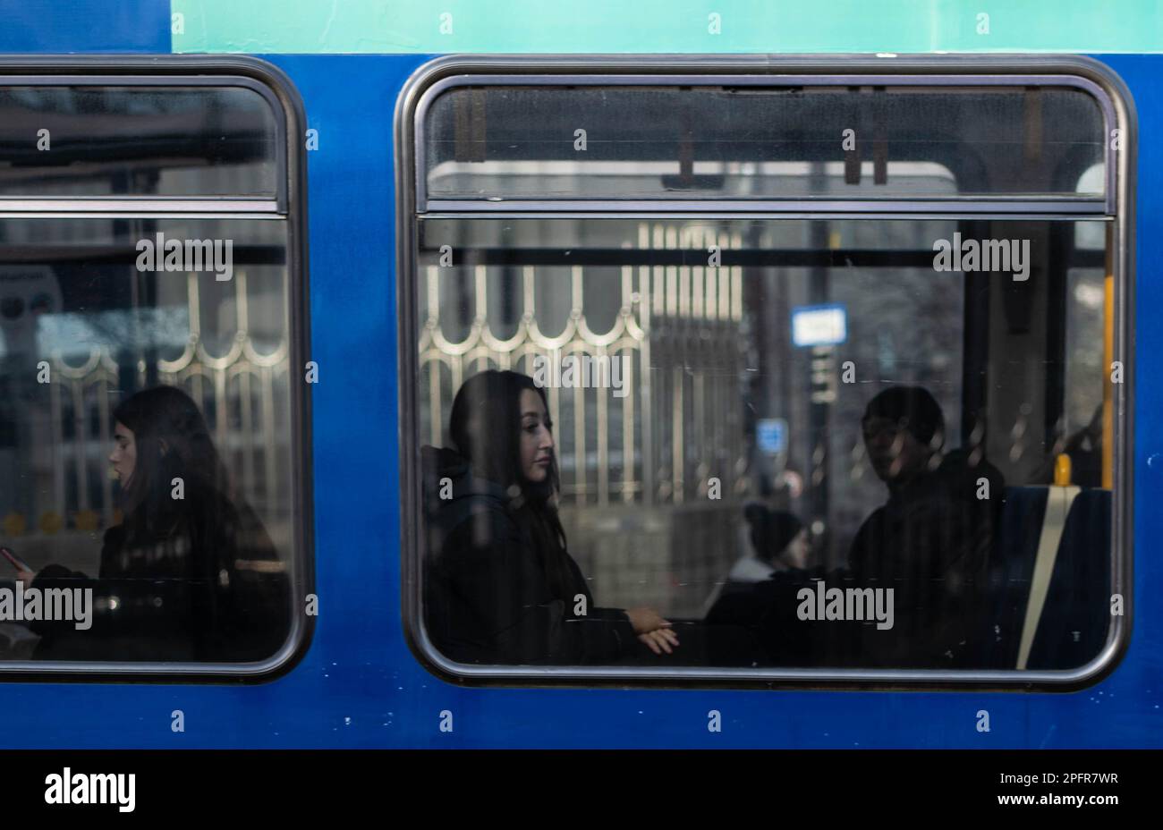 A close-up shot of passengers sitting on seats inside a train Stock ...