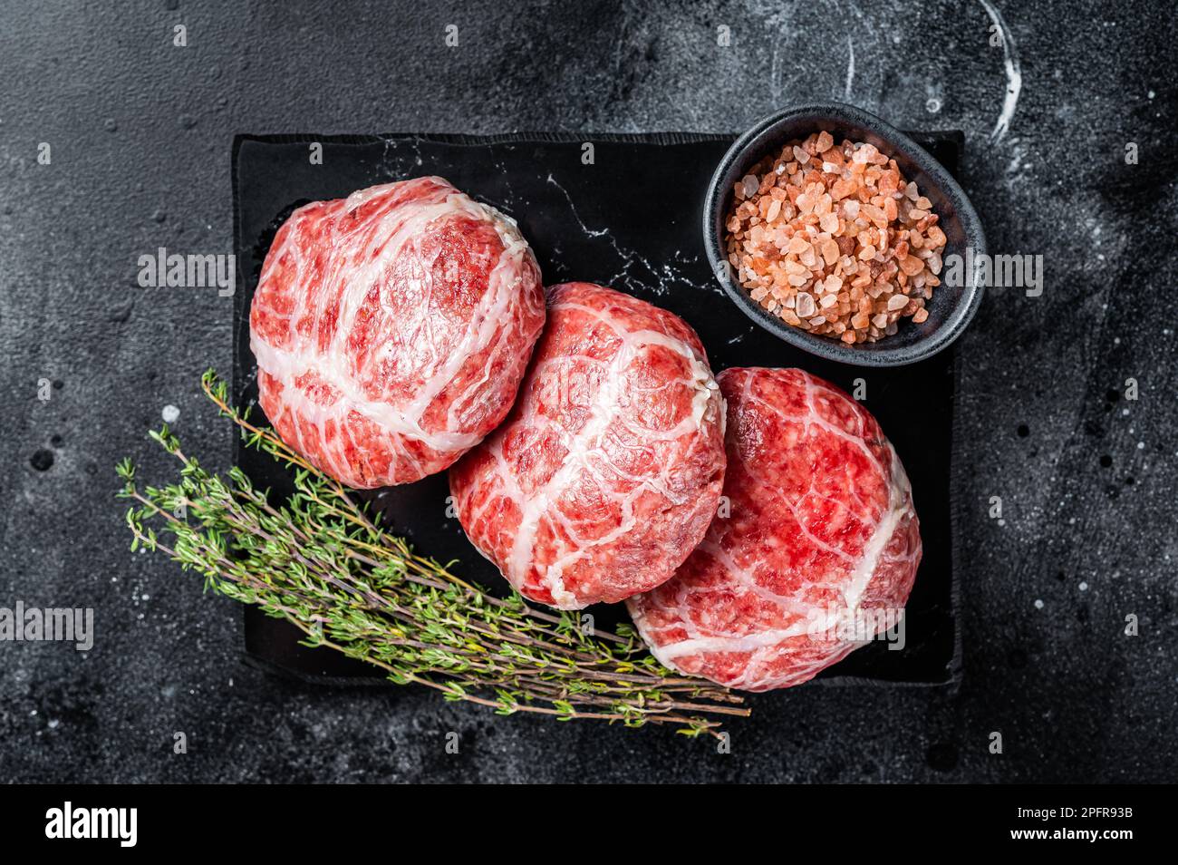 Raw Atriaux cutlets, ground pork wrapped in caul fat, swiss sausage ...