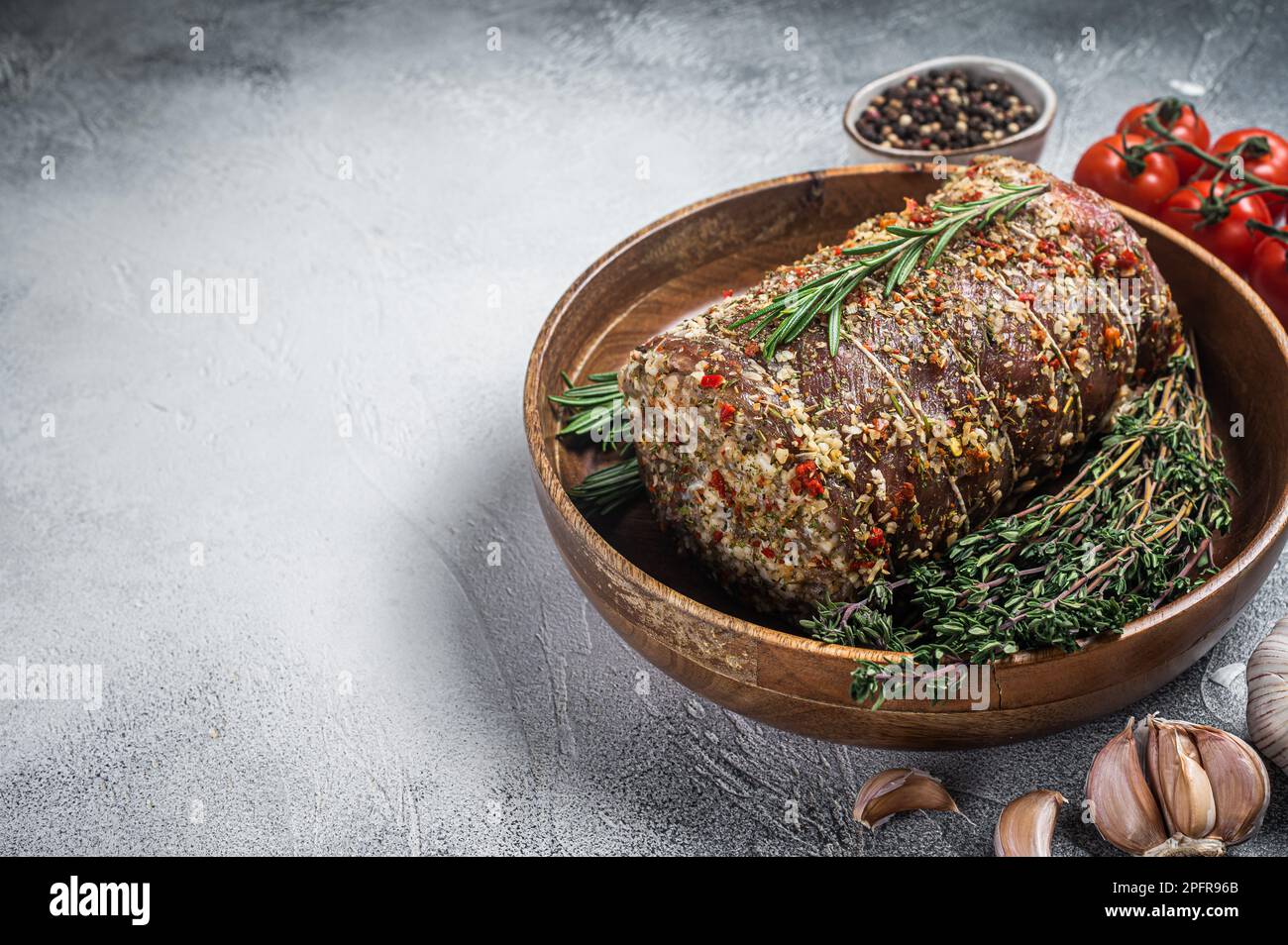Raw italian Porchetta seasoned with herbs, pork meat roll. White ...