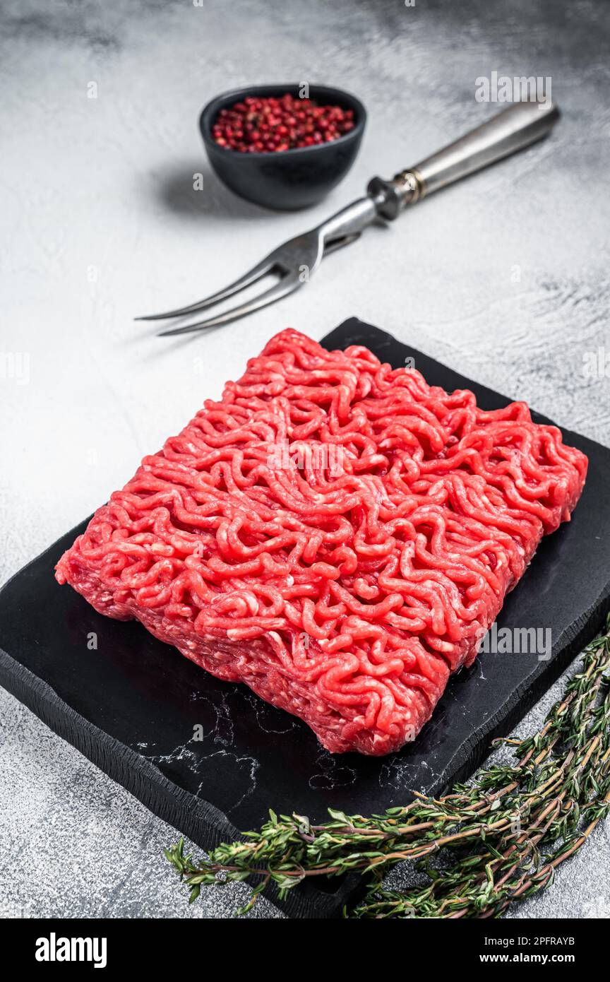 Raw mince Minced beef, ground meat with thyme and pepper. White ...
