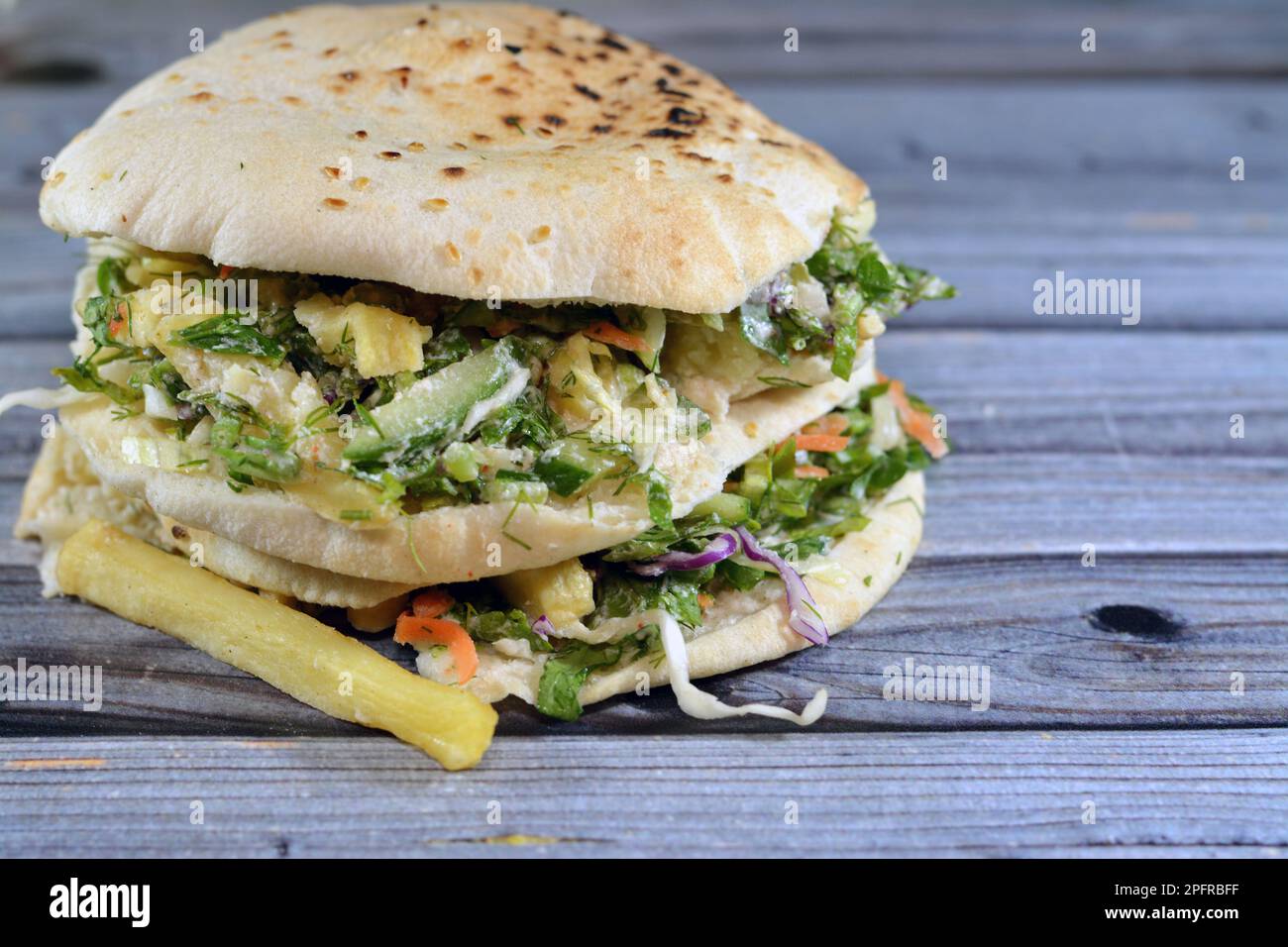 Flat Shami Syrian bread filled with french fries and green salad ...