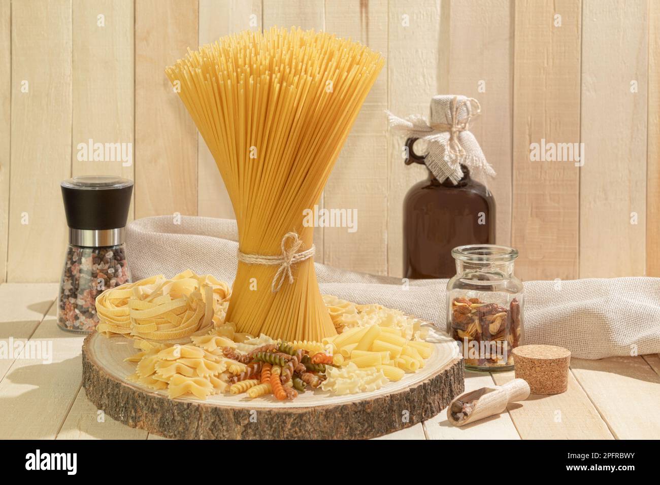 A bunch of dry spaghetti pasta in a stack horizontally. A pile of raw ...
