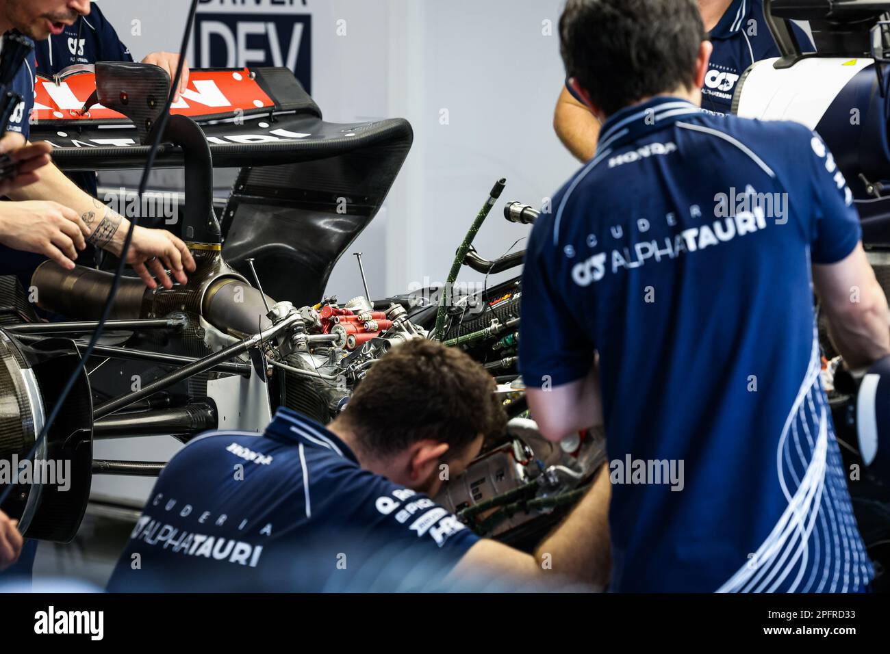 Scuderia AlphaTauri AT04, mechanics working on the car in the garage during the Formula 1 STC ...
