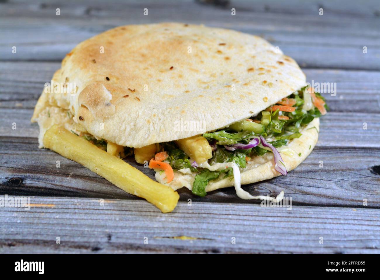Flat Shami Syrian bread filled with french fries and green salad ...