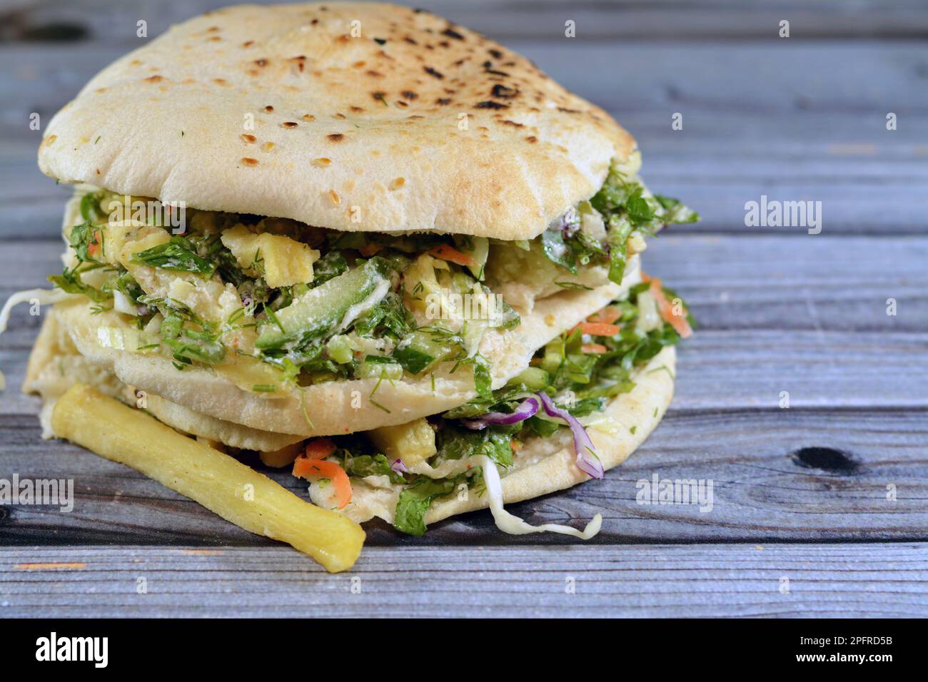 Flat Shami Syrian bread filled with french fries and green salad ...