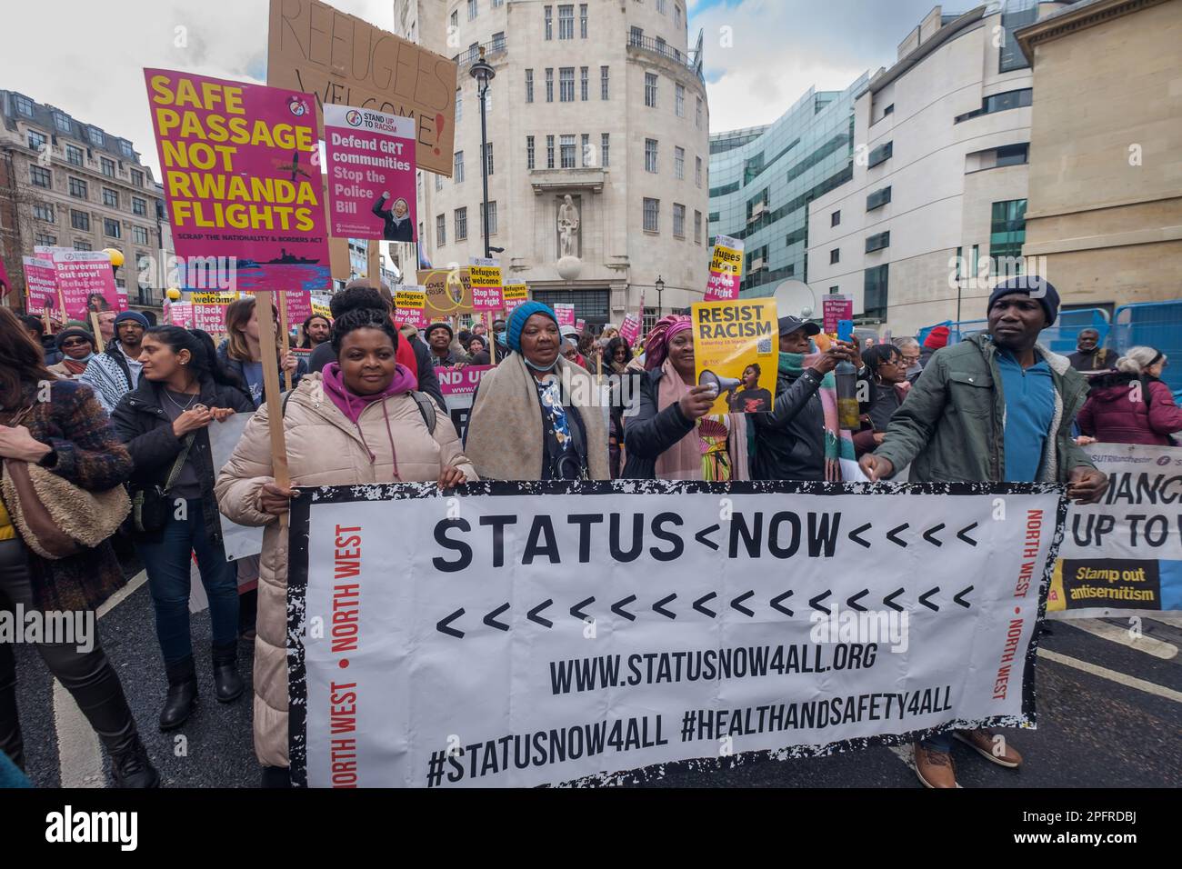 London, UK. 18 Mar 2023. Status Now banner. Thousands march through ...