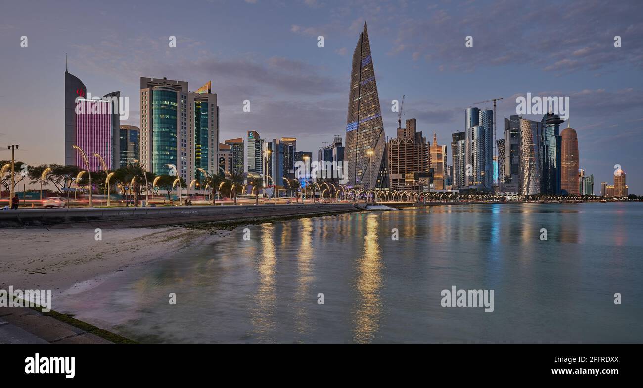 Doha Qatar skyline from corniche promenade at dusk showing West Bay ...