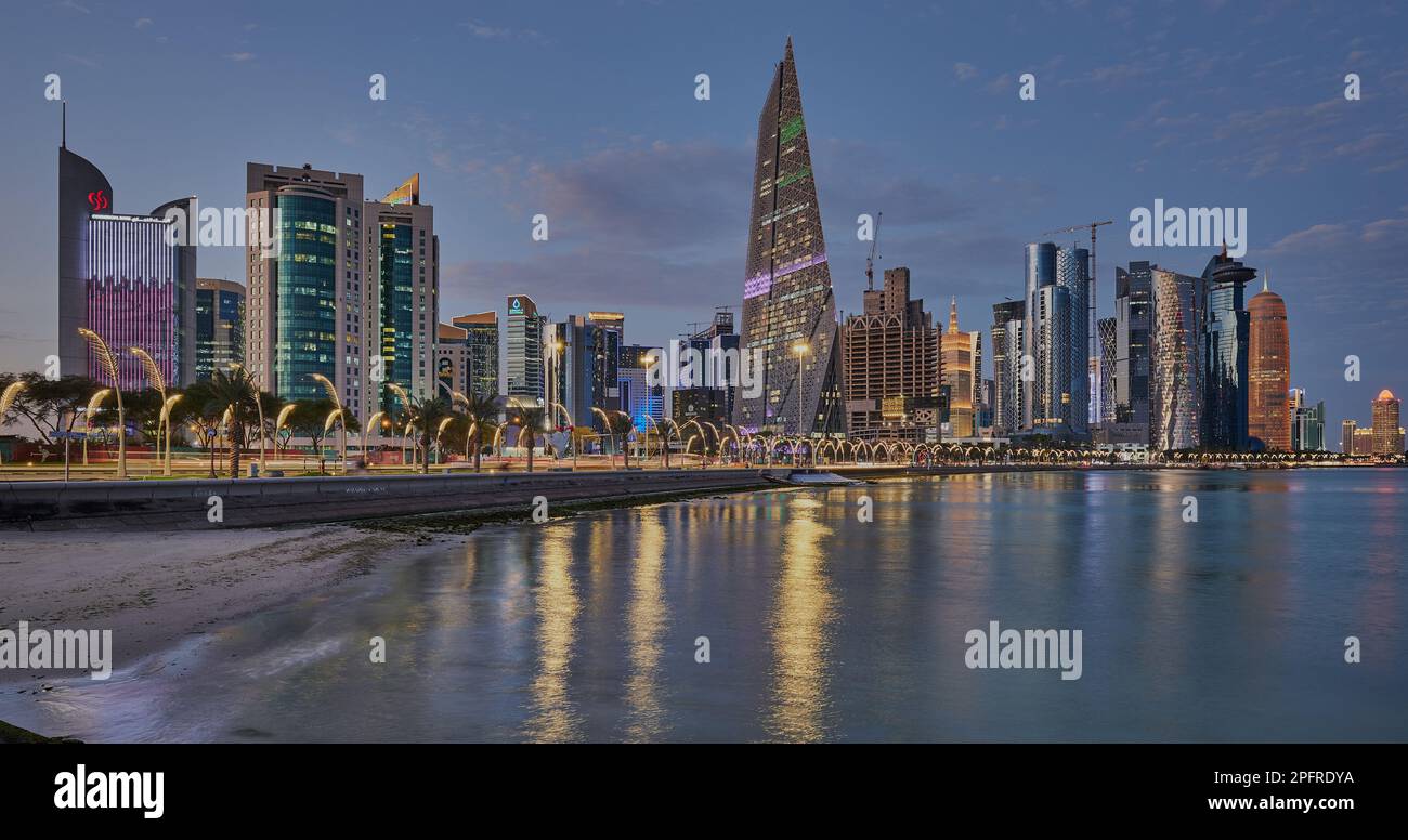 Doha Qatar skyline from corniche promenade at dusk showing West Bay ...
