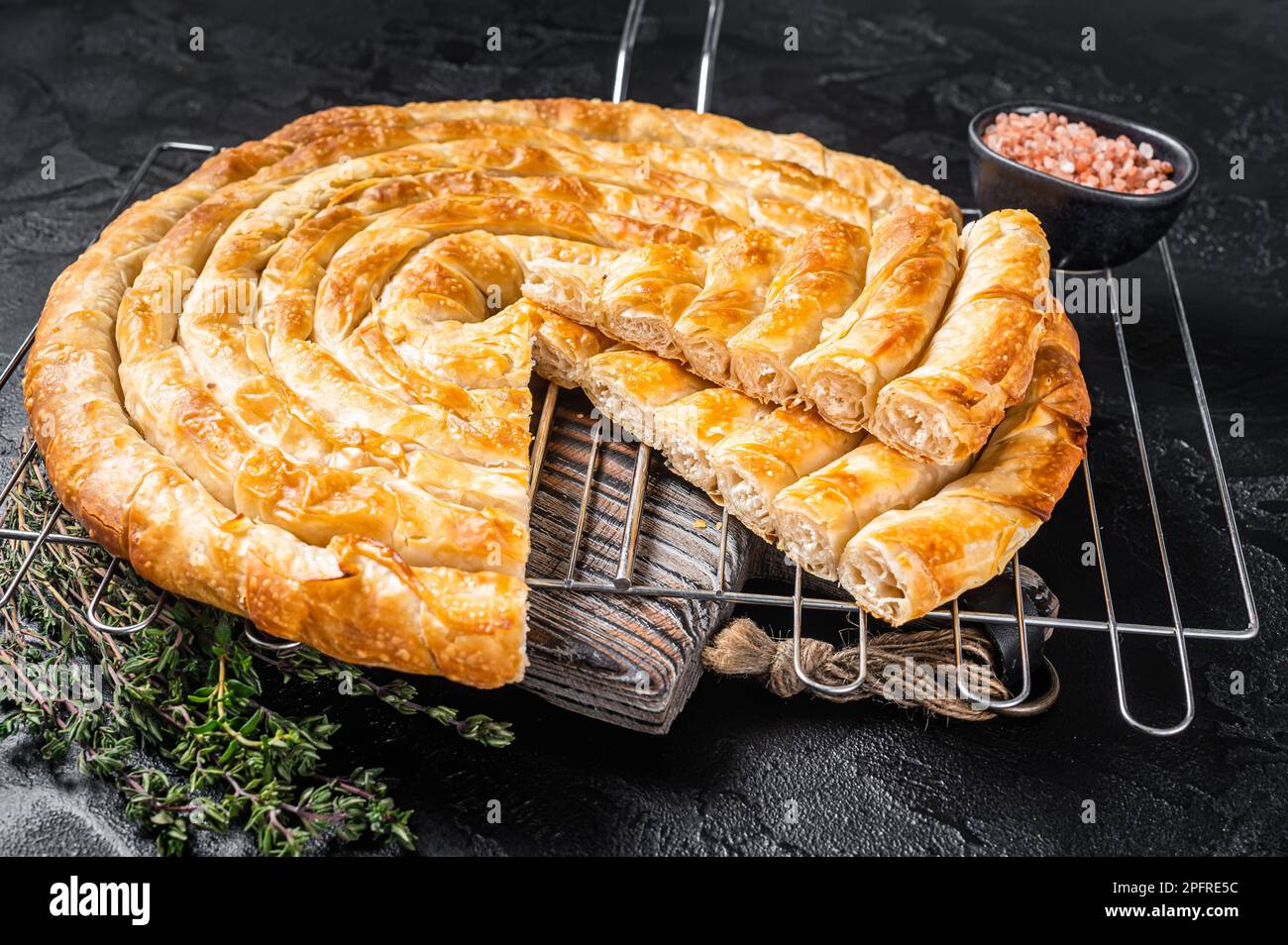 Turkish Tepsi Boregi, Round Borek cheese pie on kitchen board. Black ...