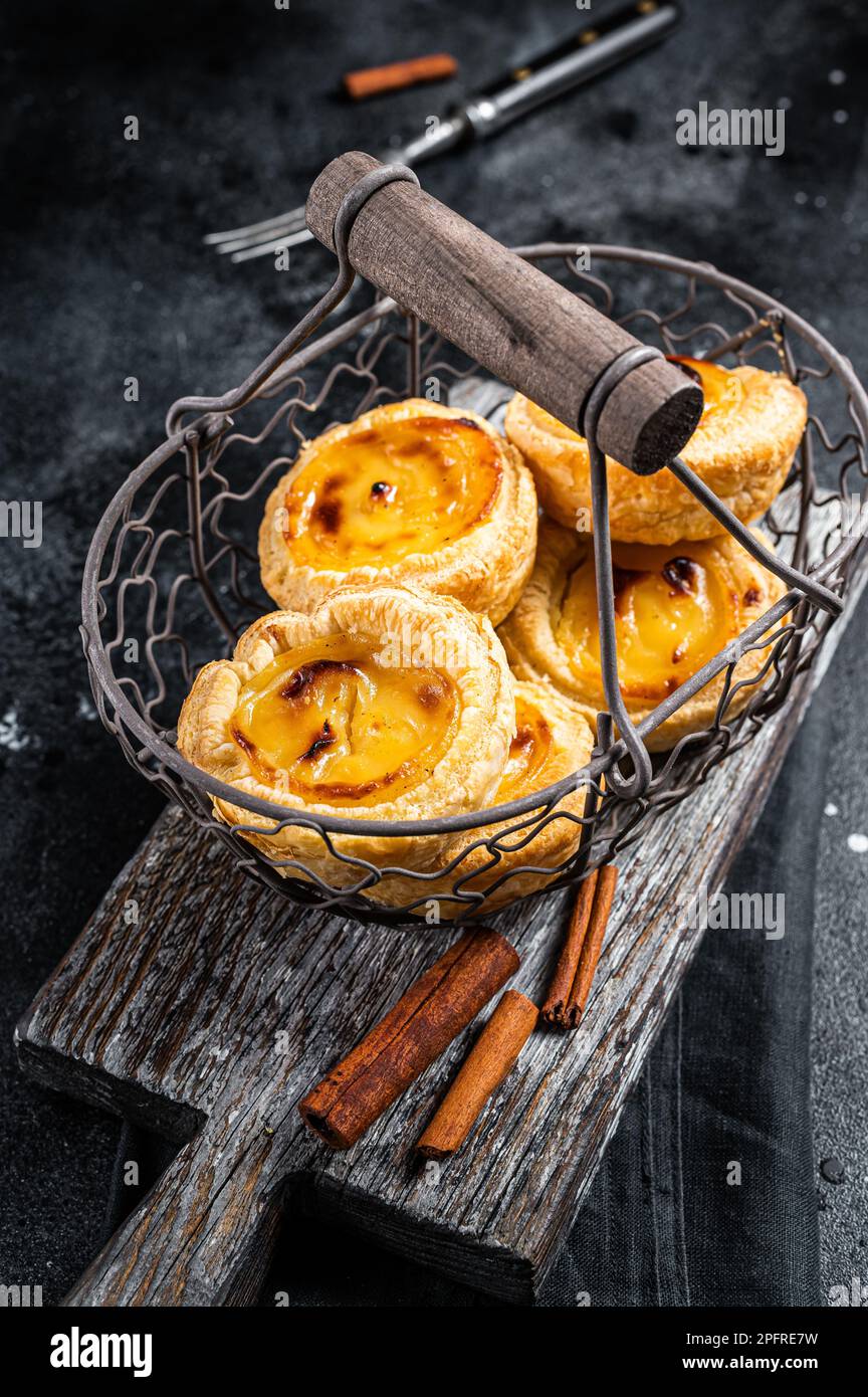 Traditional Lisbon Pasteis de nata in a basket. Black background. Top ...