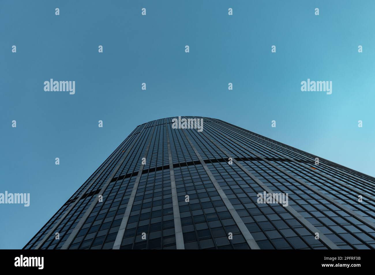 A view of a towering skyscraper, with its multiple stories and windows ...