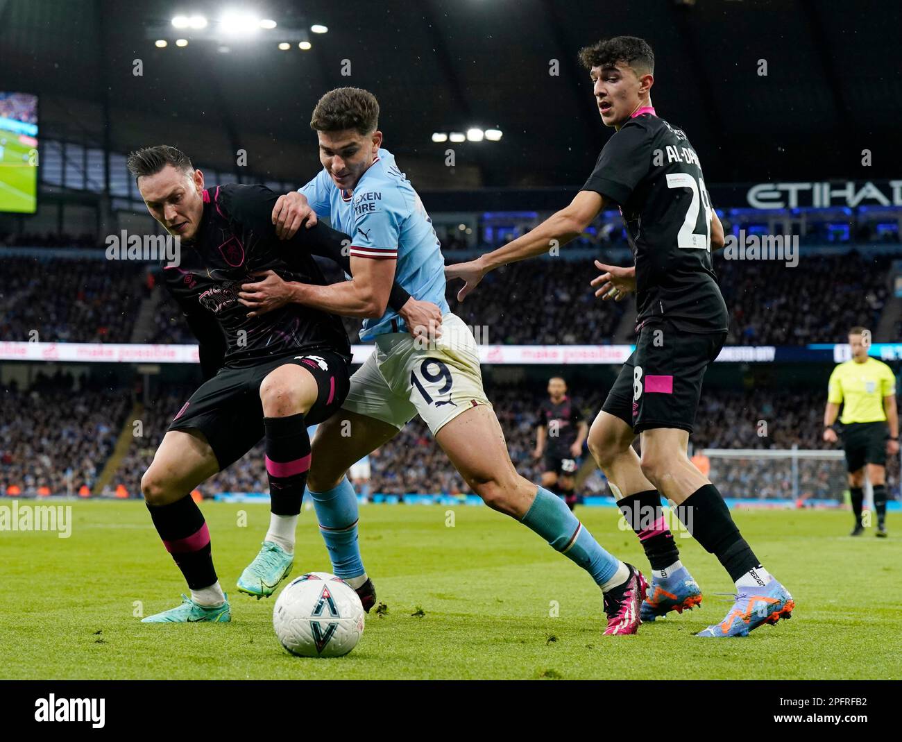 Manchester, UK. 18th Mar, 2023. Connor Roberts of Burnley and Ameen Al-Dakhil of Burnley tussle ...