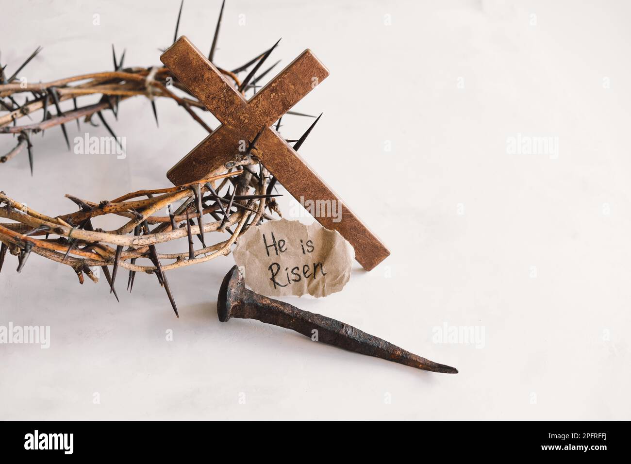 He is Risen. Jesus Crown Thorns and nails and cross on a white ...