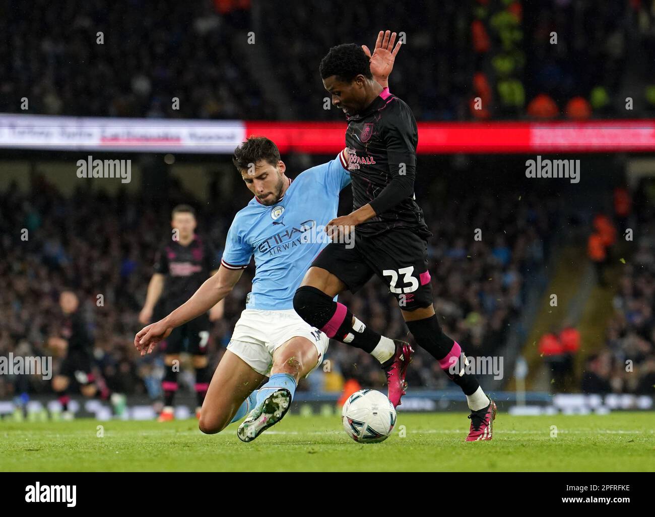 Manchester City's Ruben Dias (left) tackles Burnley's Nathan Tella ...