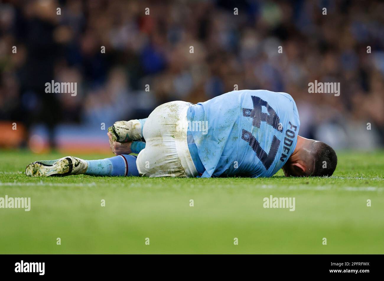 Manchester City's Phil Foden looks in pain after a challenge during the ...