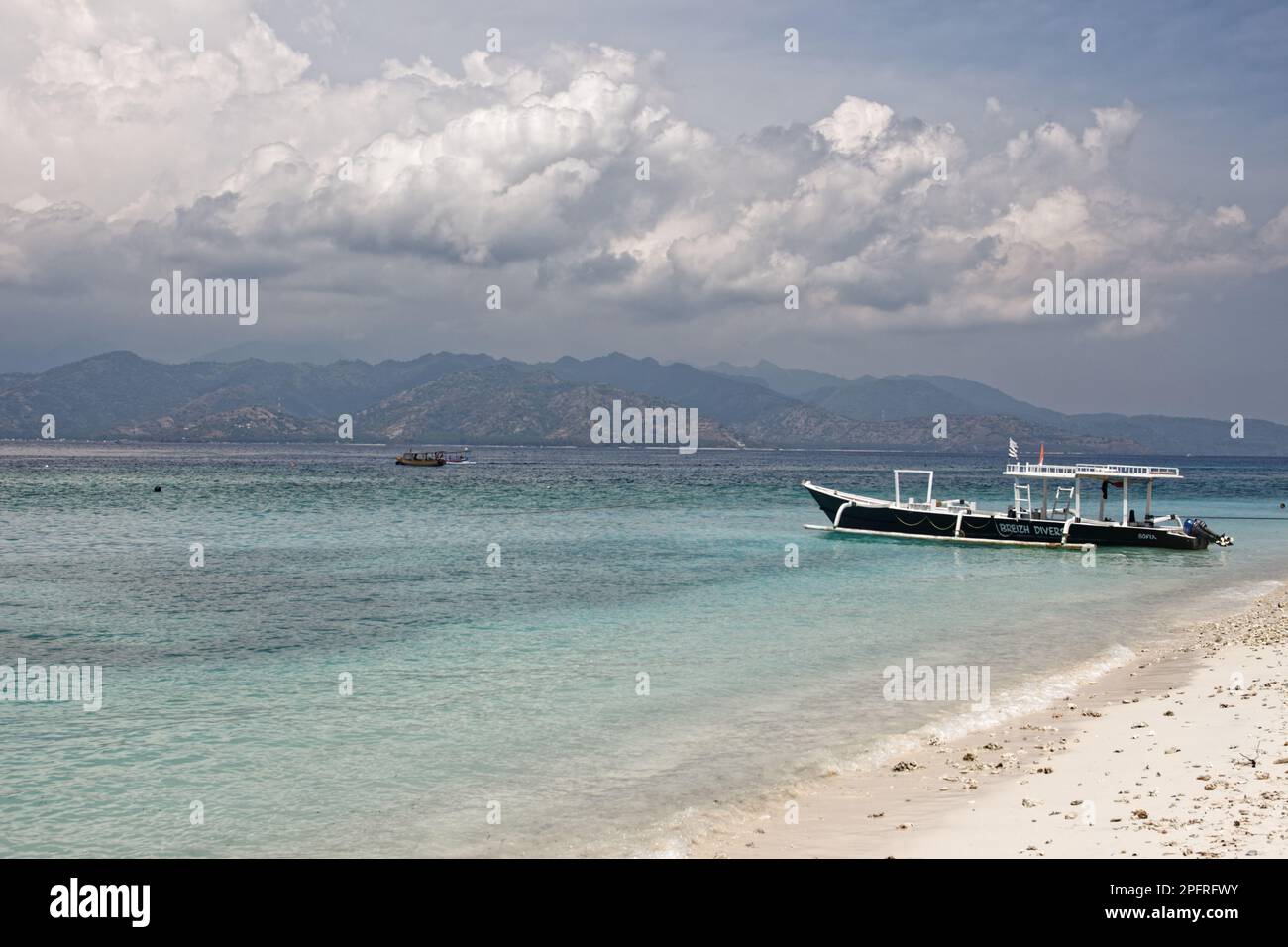 The sandy beach of Gili Trawangan, with Lombok Island in the background ...