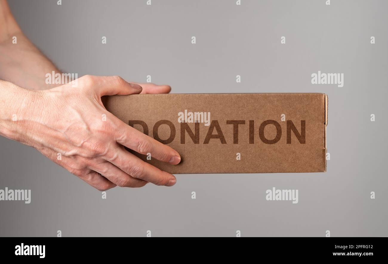 Hand holding donation box in hand, donating. Charity, charitable help ...