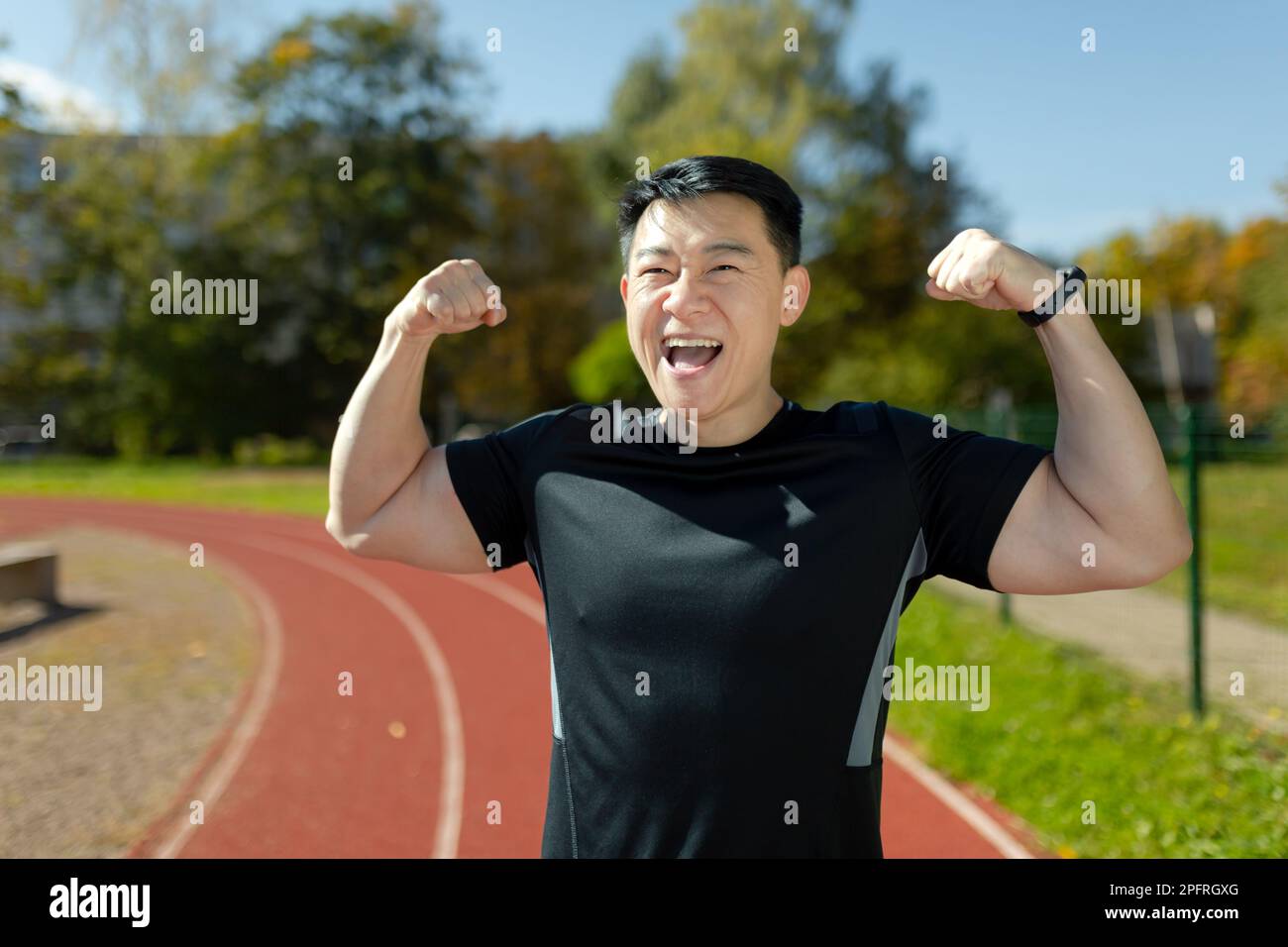 Winning the competition. A young Asian man, an athlete, a runner ...