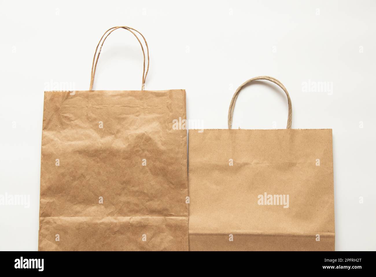 Brown paper packaging bag isolated on white background Stock Photo - Alamy