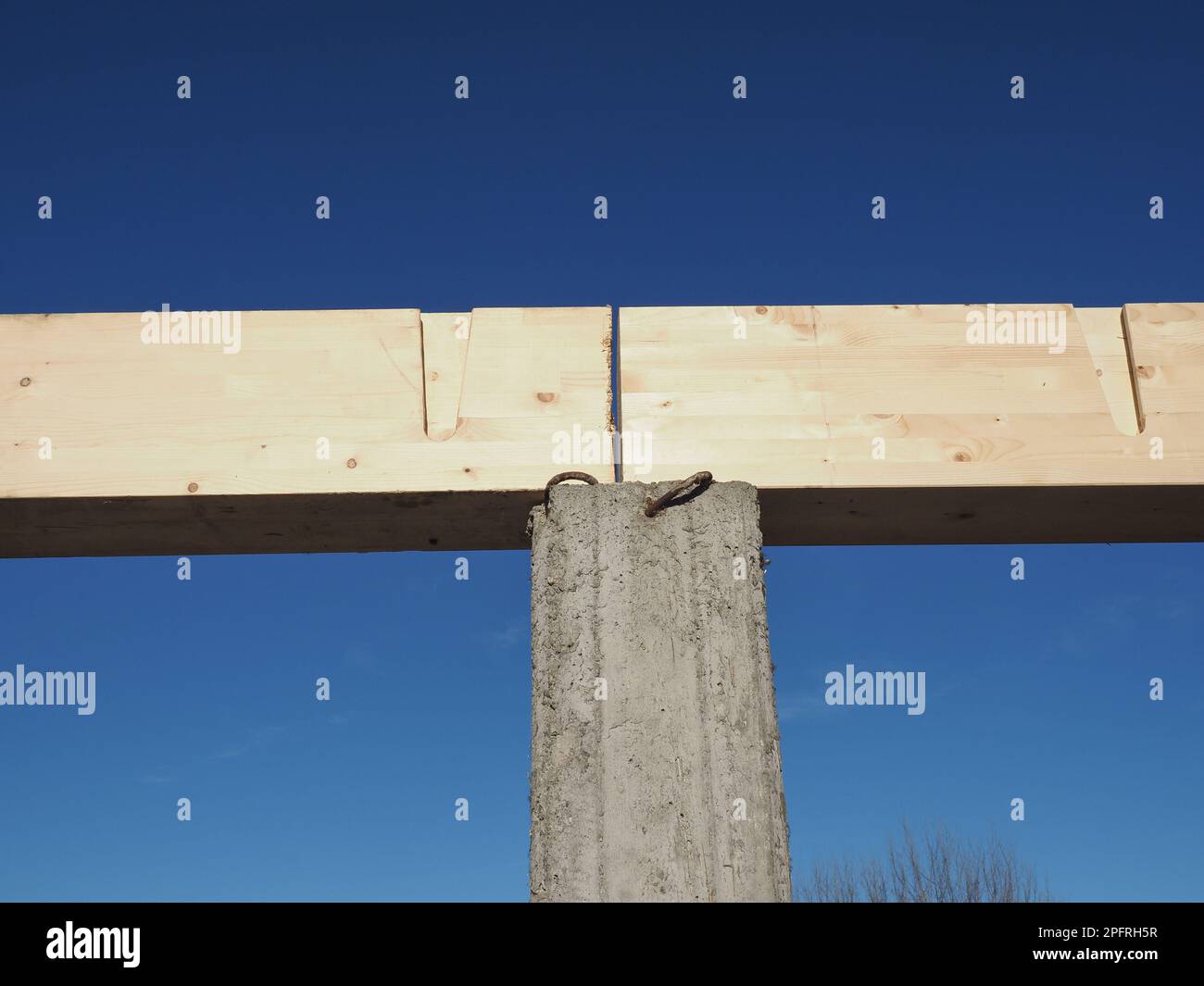 wooden beam on concrete pillar for roof construction works in a ...