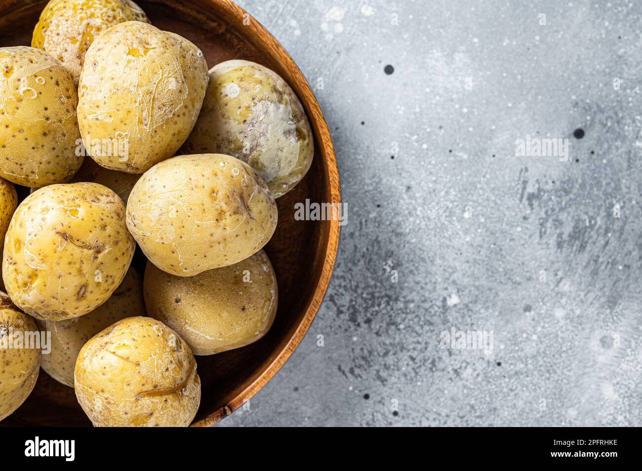 Canarian boiled potatoes papas arrugadas. Gray background. Top view ...