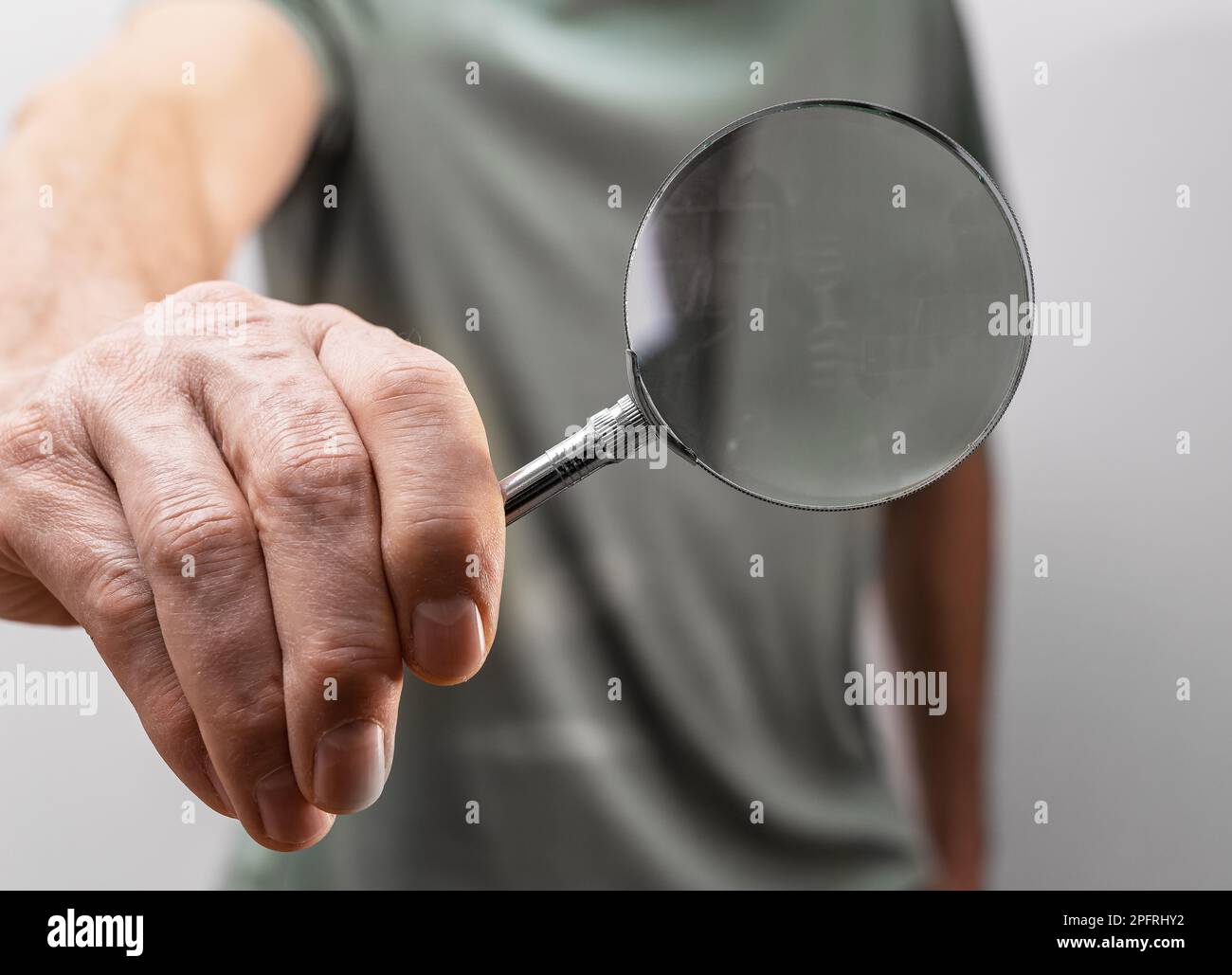 Hand holding magnifying lens, loupe, magnifier. Search and find ...