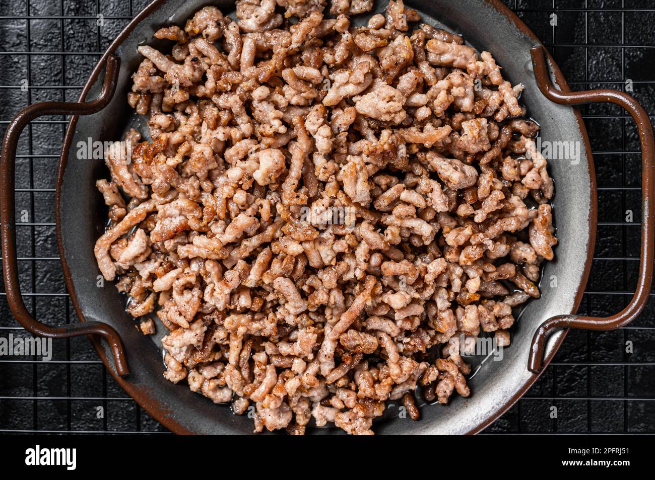 Fried mince beef and lamb meat in a tray with spices. Black background ...