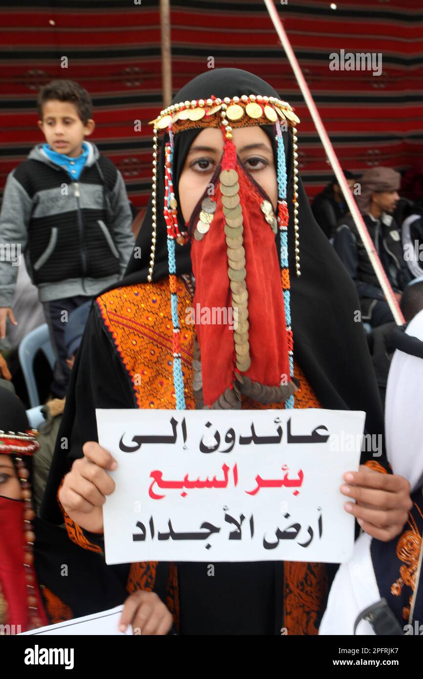 Palestinians wearing traditional Arabic headdress participate during ...