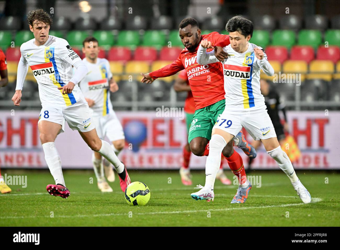 Westerlo's Nikolas Madsen, Oostende's Thierry Ambrose and Westerlo's Yusuke Matsuo fight for the ...