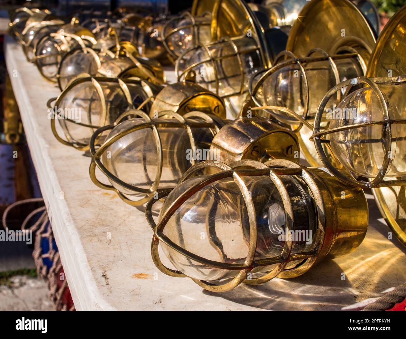 Rows of vintage brass lamps on display at a local flea market ...