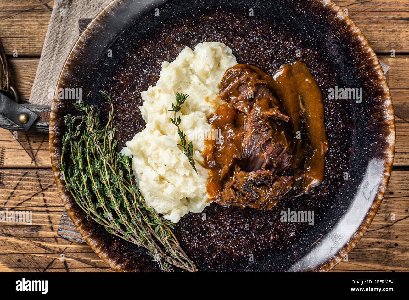 Beef cheeks stewed in red wine sauce with mashed potatoes. Wooden ...