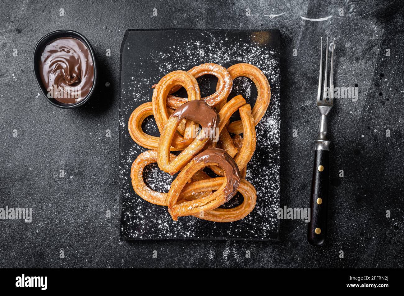 Traditional mexican dessert churros with chocolate sause. Black ...