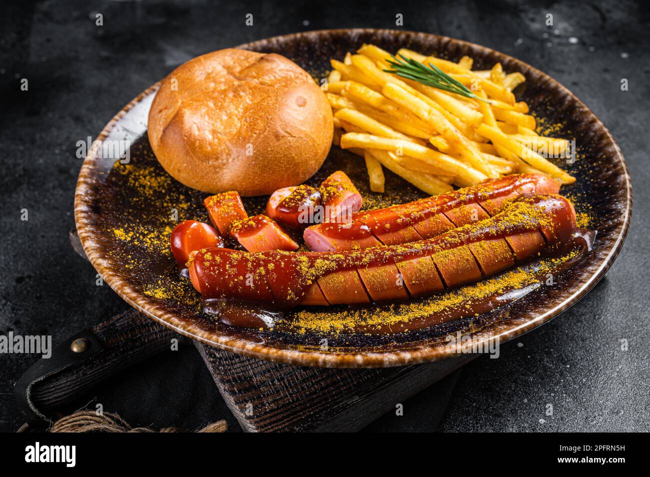 German currywurst sausage, curry wurst served with French fries. Dark ...
