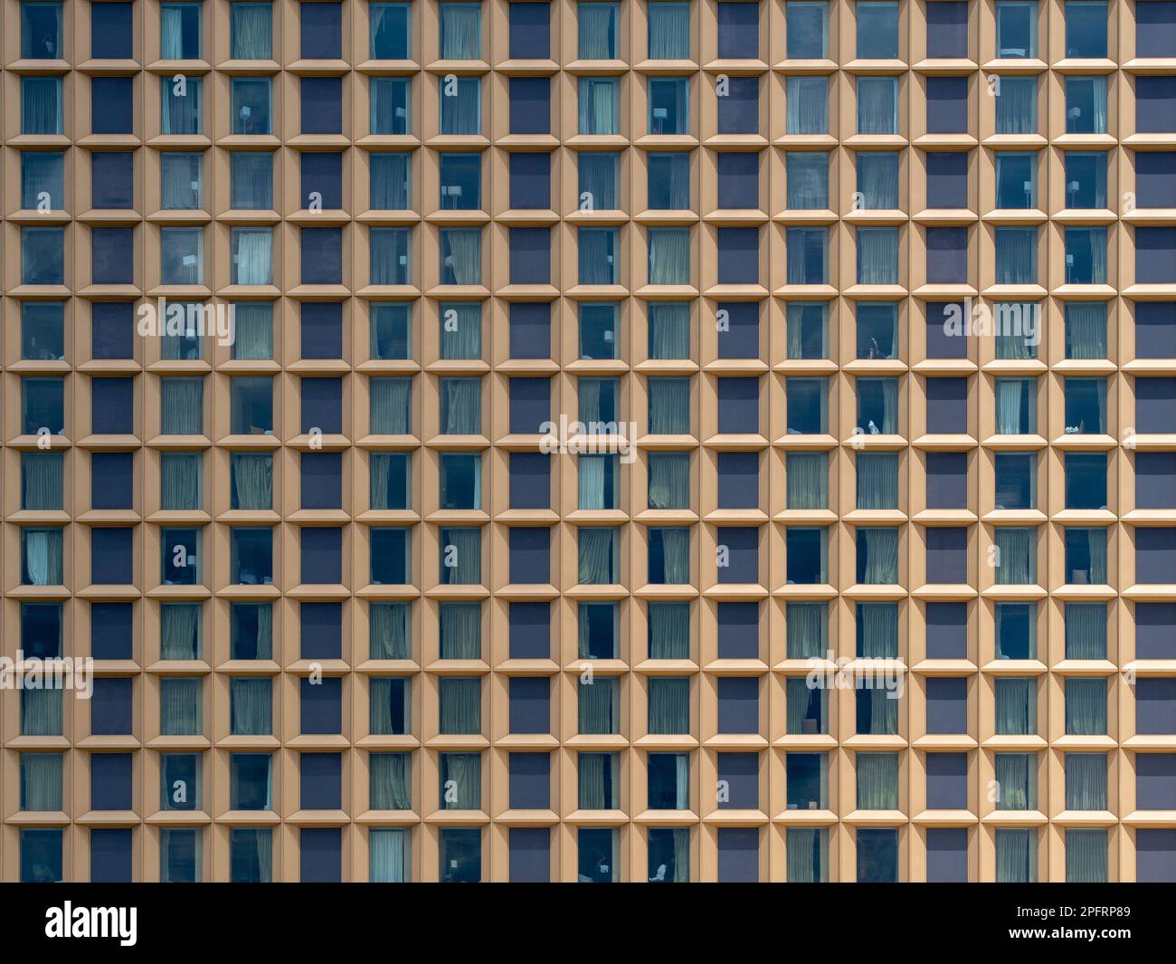 Windows on a hotel facade with different arrangements of the curtains ...