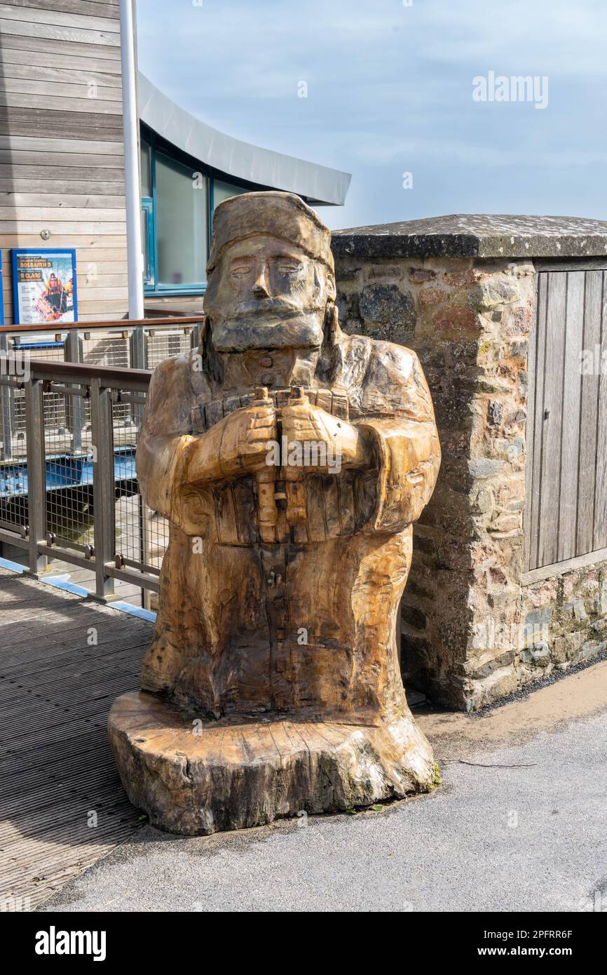 Wooden sculpture of a lifeboatman outside lifeboat house in Tenby Stock ...