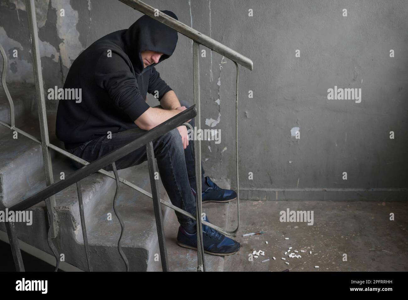 Addict in an abandoned house, experiencing a drug addiction crisis ...