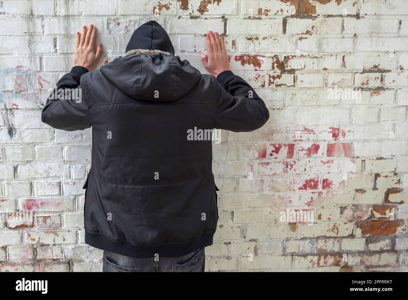 Addict on a brick wall background. Man experiencing a drug addiction ...