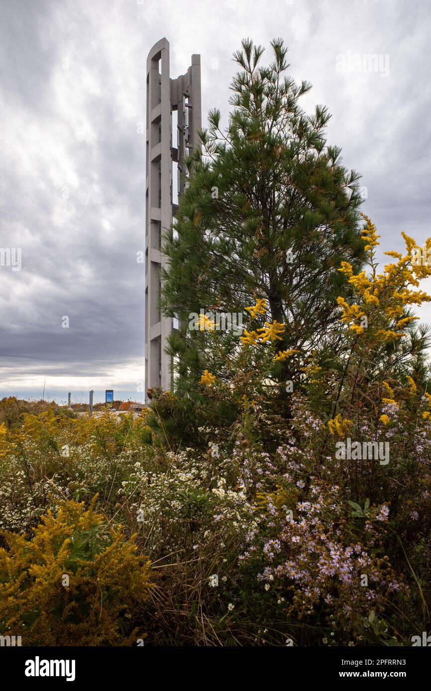 Tower of Voices behind flowers against cloudy sky at Flight 93 National ...