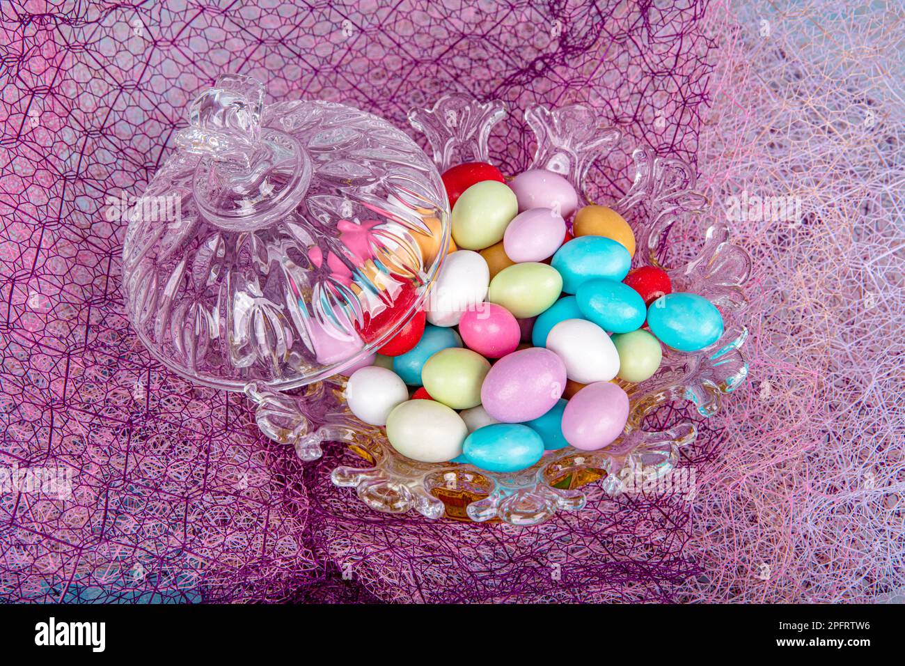 Almond candies.Colorful candies in glass bowl served with tea; almond ...