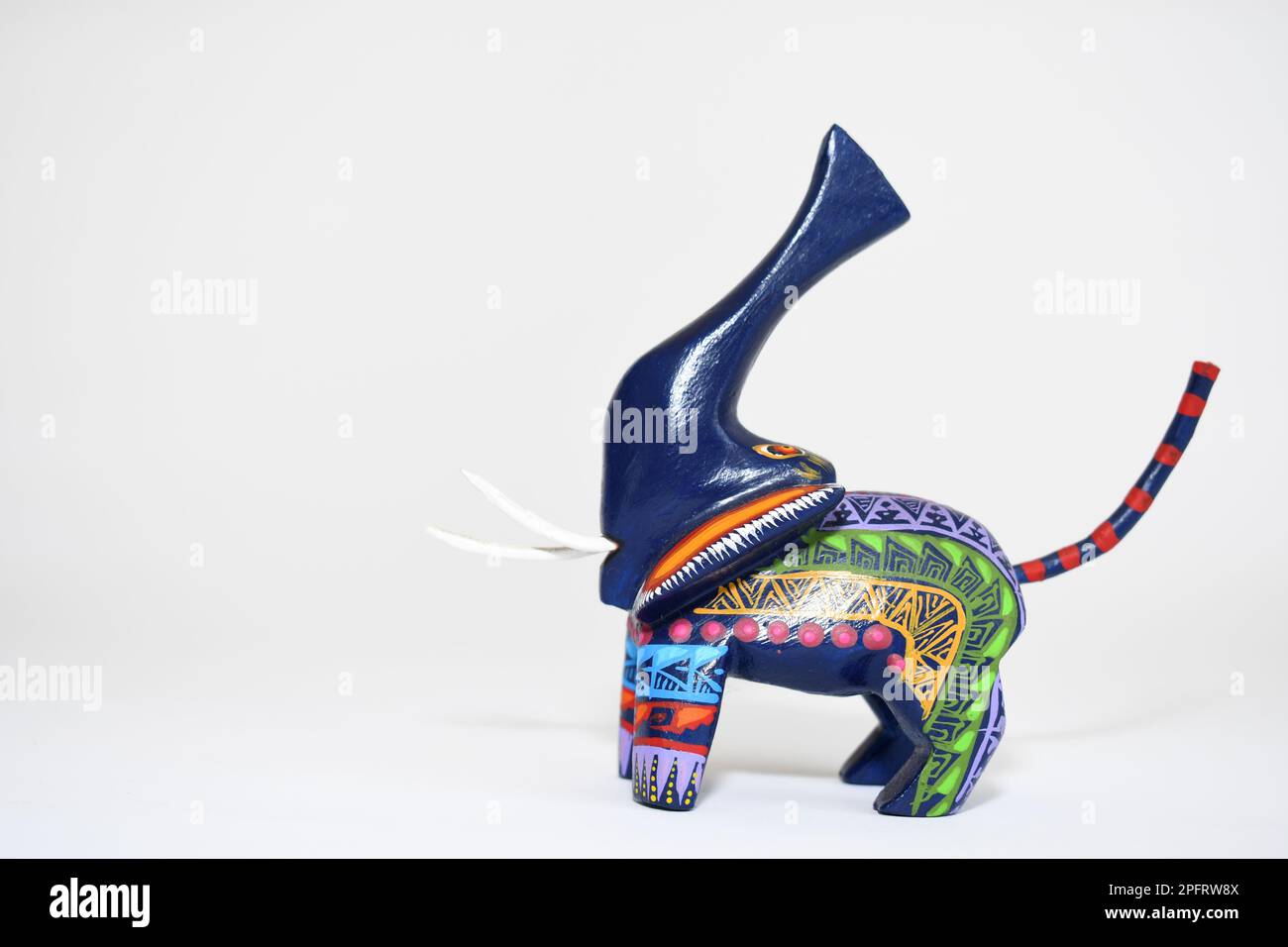 Colorful alebrije. Mexican hand painted wooden handicraft in the shape ...