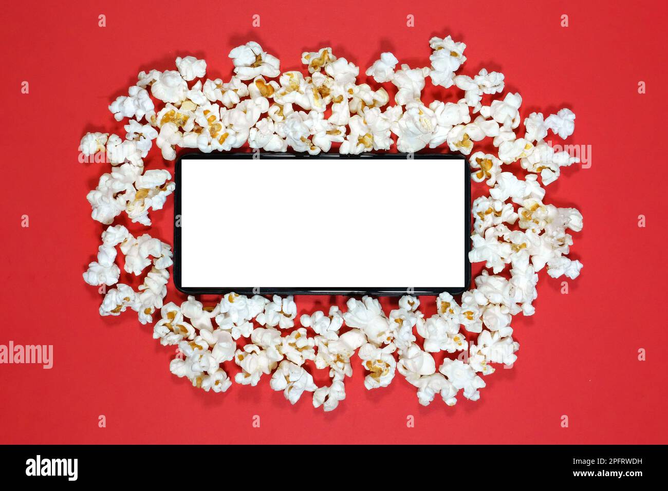 Popcorn and phone on a colored background. Top view of popcorn texture ...