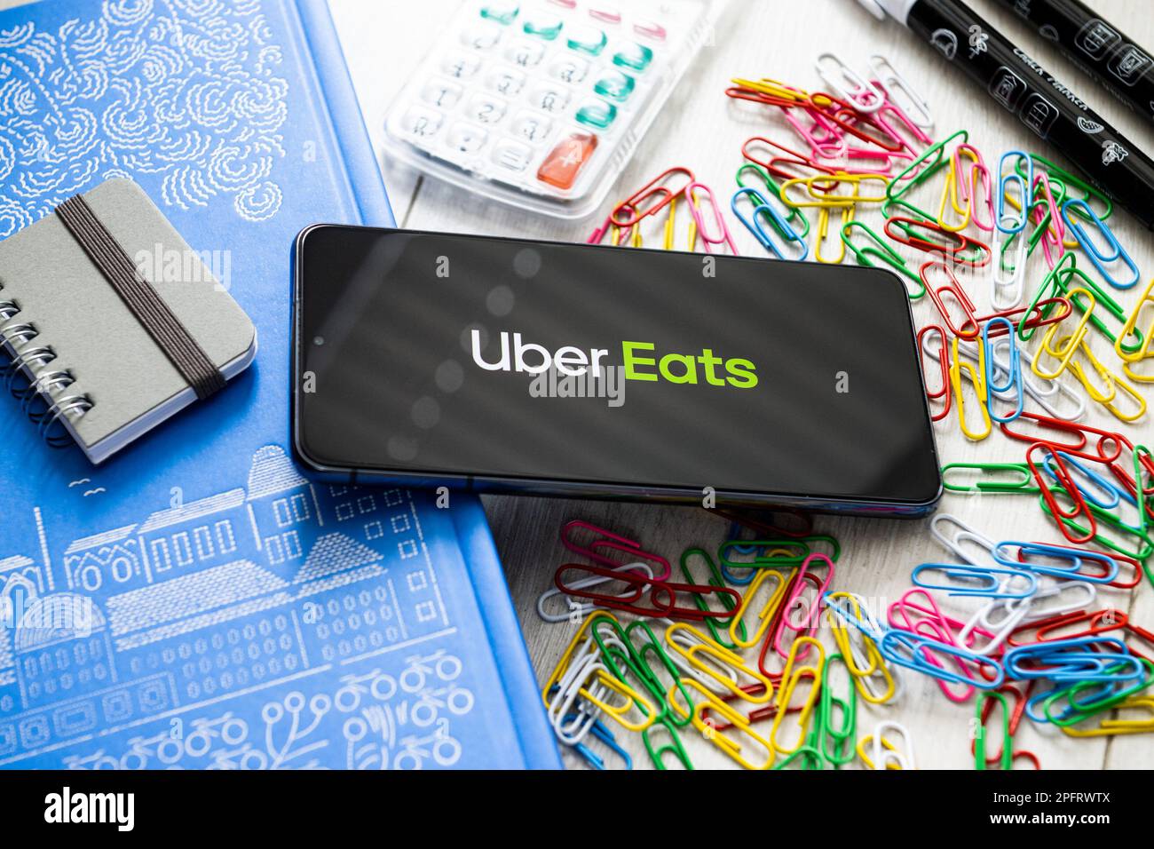In this photo illustration the Uber Eats logo seen displayed on a ...