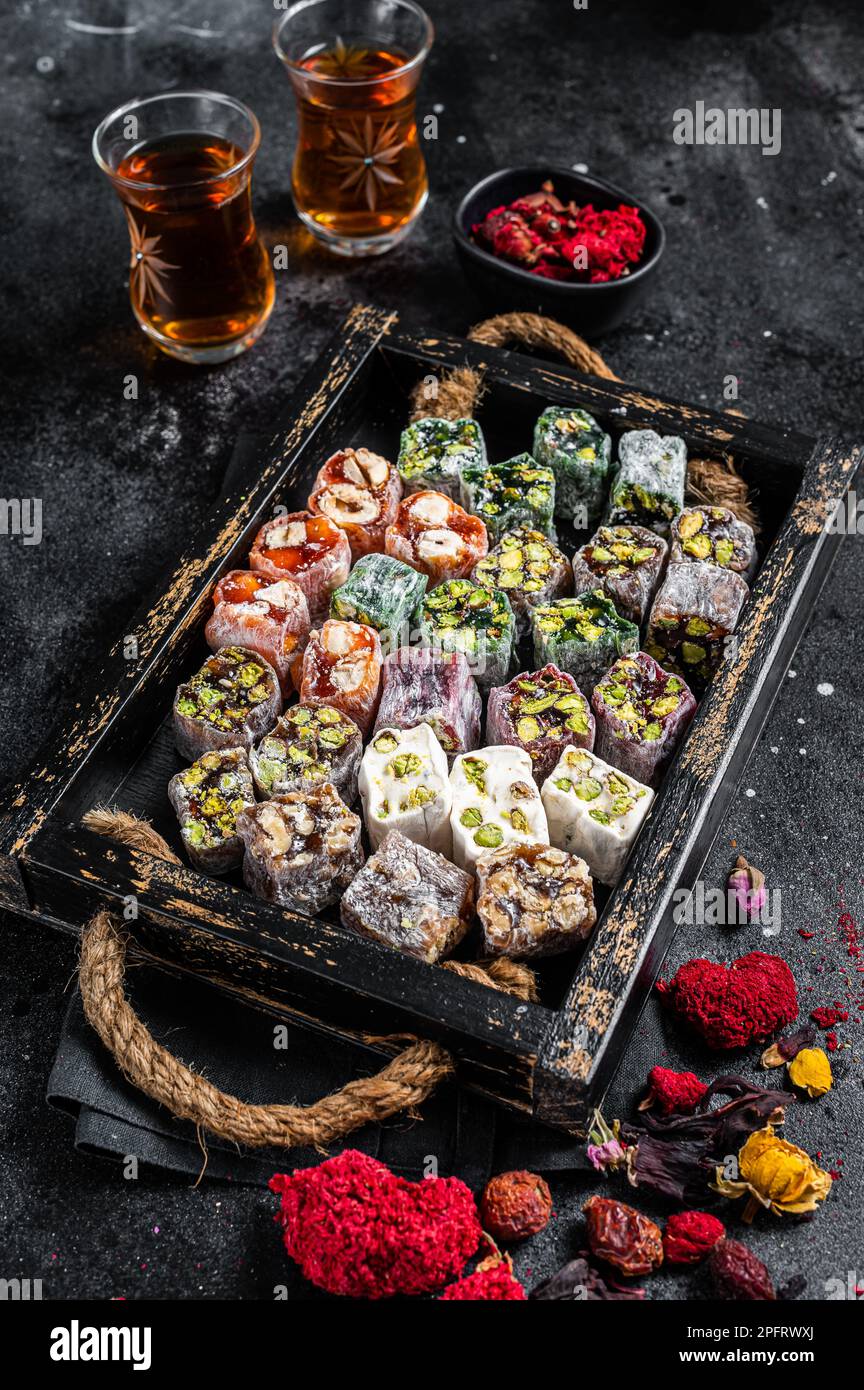 Turkish Delight Lukum, Oriental sweets with nuts and black tea. Black ...
